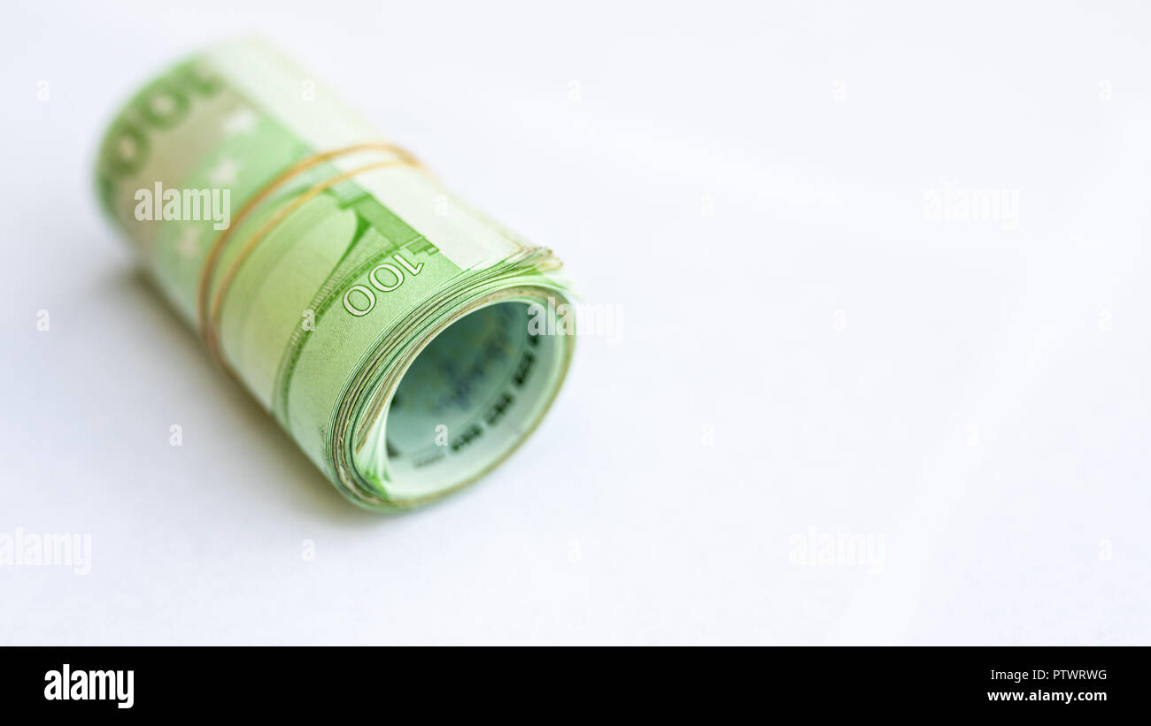 Roll of few thousands of euro currency. Isolated on white background ...