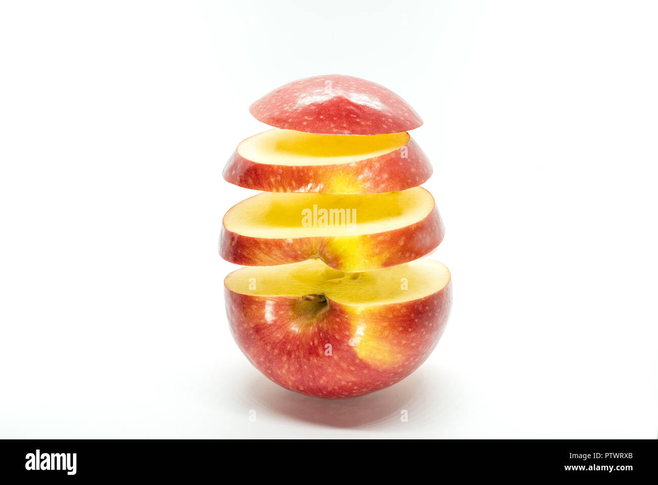 Gala apple cut in half with half of pieces floating in the air Stock ...