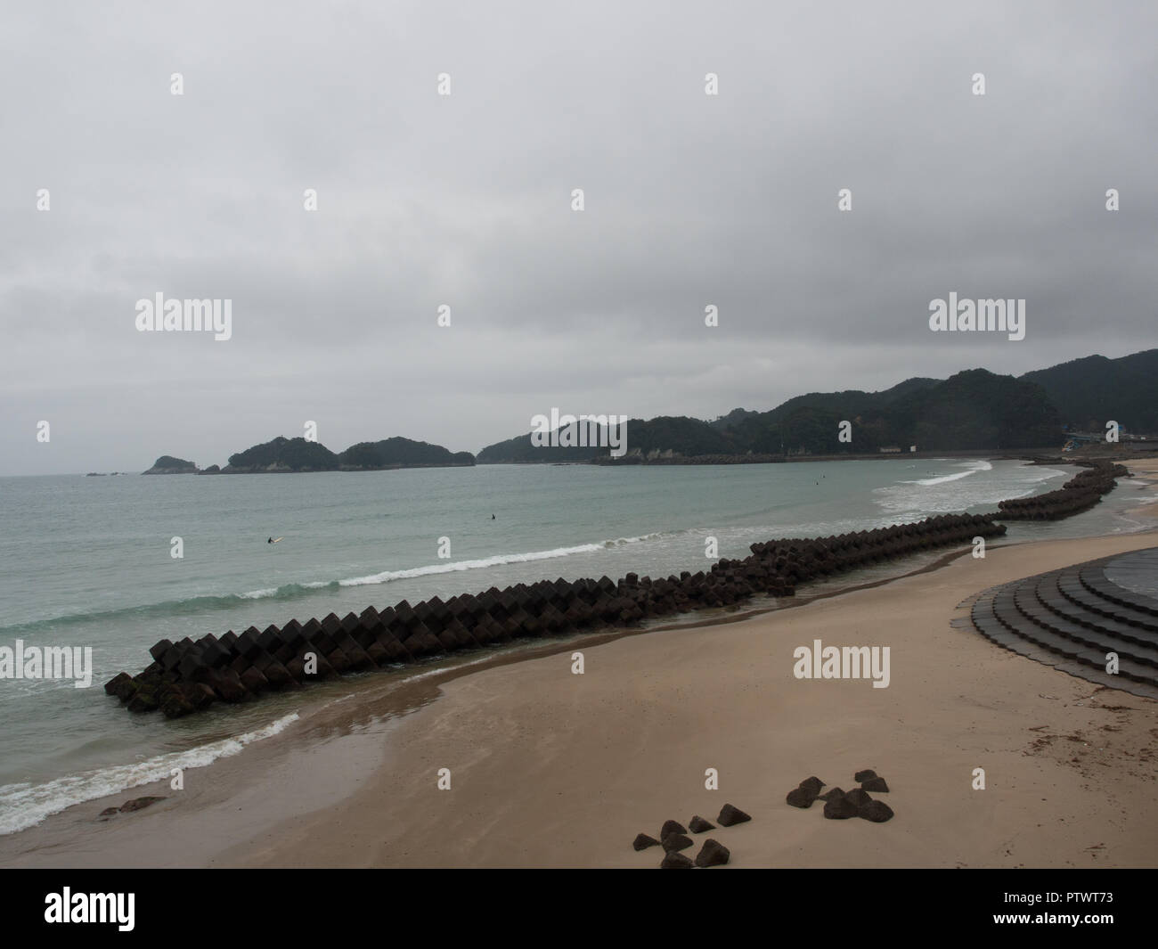 Tetrapod reefs on sandy beach with surfers and circe stairs, Shishikui ...