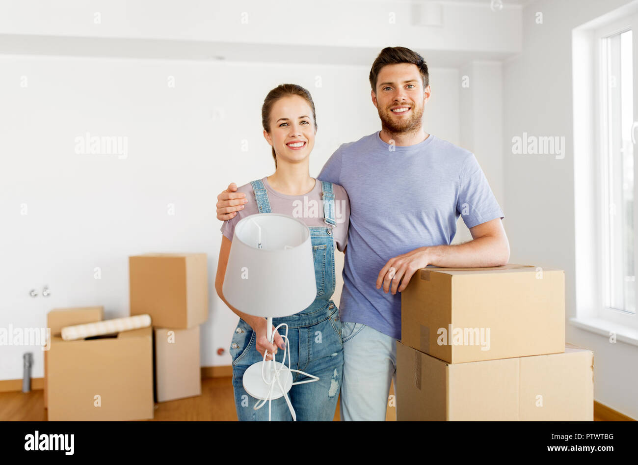 couple with boxes and lamp moving to new home Stock Photo - Alamy