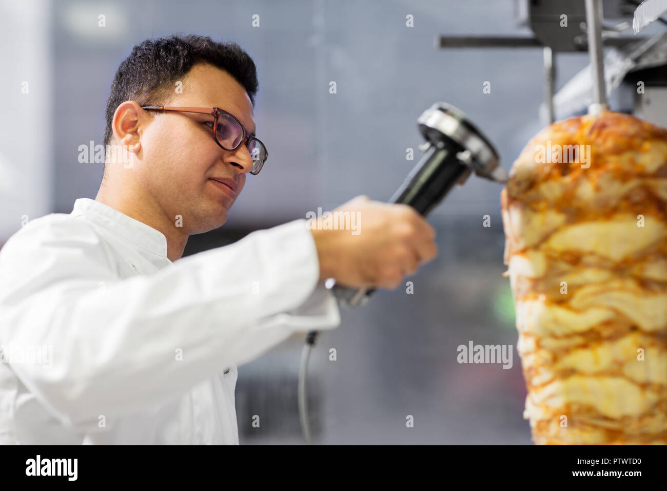 chef slicing doner meat from spit at kebab shop Stock Photo - Alamy