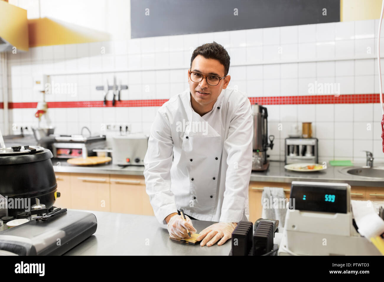 chef at fast food restaurant writing order Stock Photo - Alamy