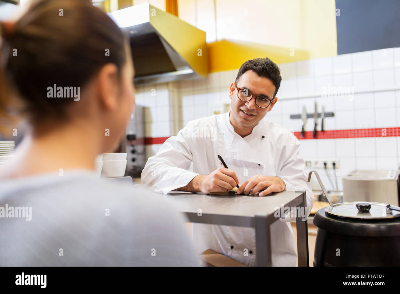 chef at fast food restaurant writing order Stock Photo - Alamy
