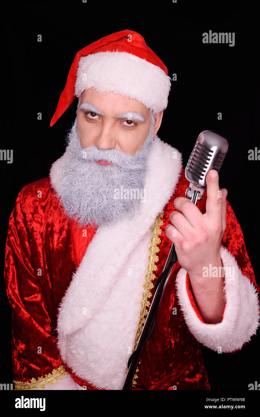 santa claus with a microphone sings a song on a dark background Stock ...