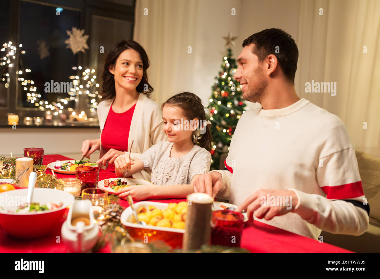 happy family having christmas dinner at home Stock Photo - Alamy