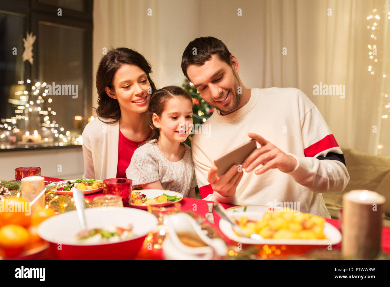 Family having dinner with phone hi-res stock photography and images - Alamy