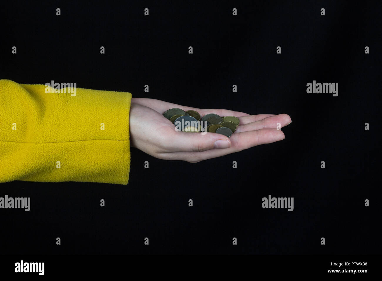 Hand dropping coins hi-res stock photography and images - Alamy