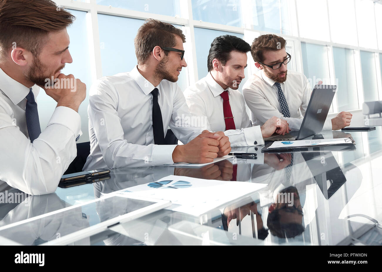 business team sitting at a table in the conference room Stock Photo - Alamy
