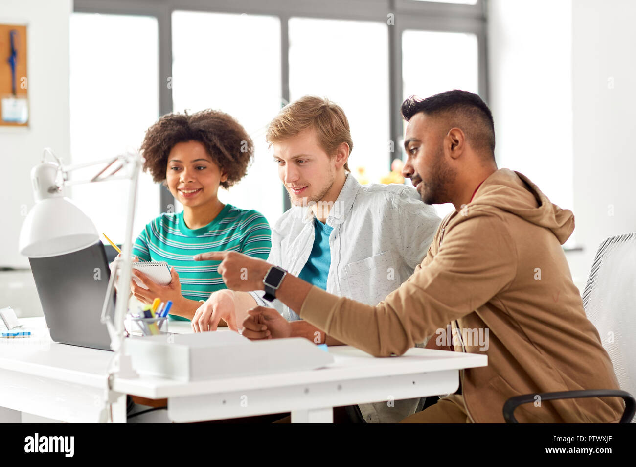 happy creative workers with laptops at office Stock Photo - Alamy
