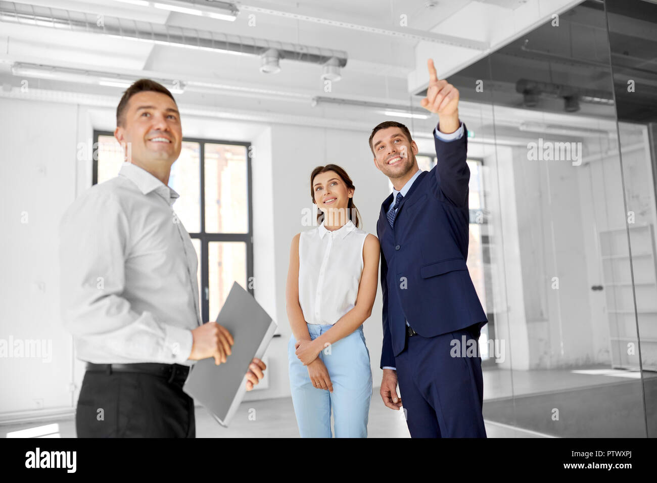realtor showing new office room to customers Stock Photo - Alamy