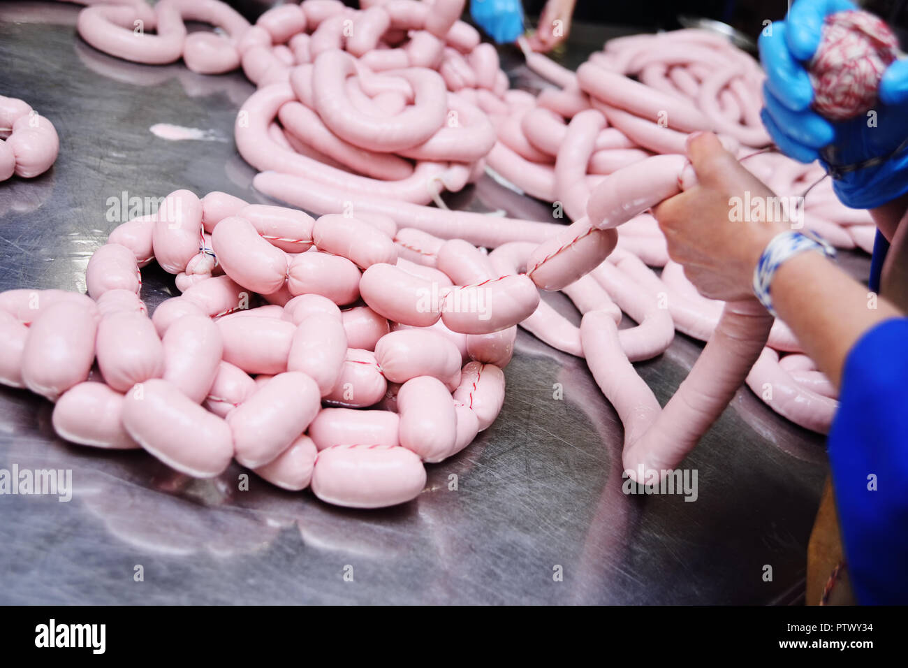 food production of sausage at a meat-packing plant. Butchers process ...