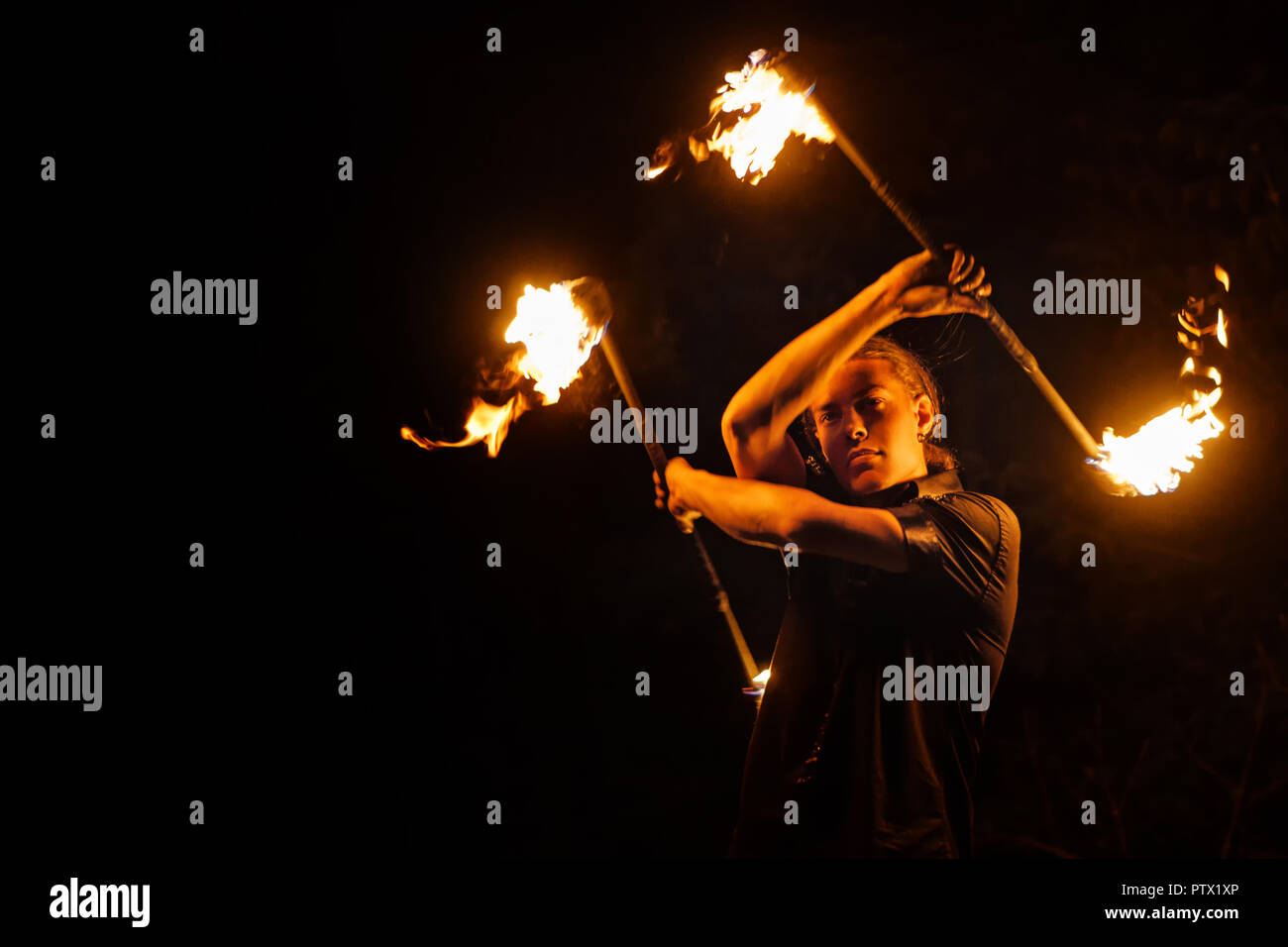Fire show. Fakir dances with two Staff. Night performance. Dramatic ...