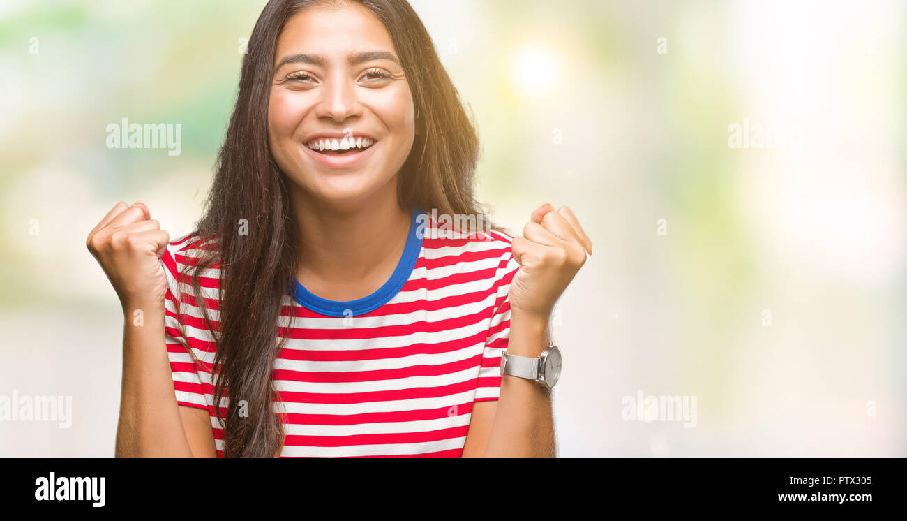 Young beautiful arab woman over isolated background celebrating ...