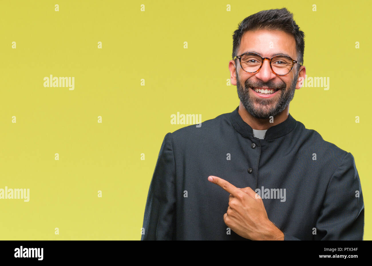 Adult hispanic catholic priest man over isolated background cheerful ...