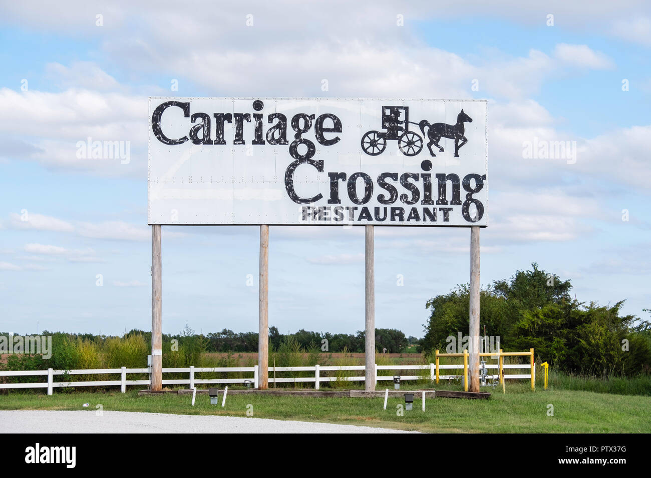A large sign advertising an Amish Restaurant called Carriage Crossing ...