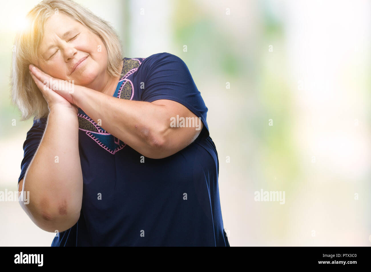 Senior plus size caucasian woman over isolated background sleeping ...