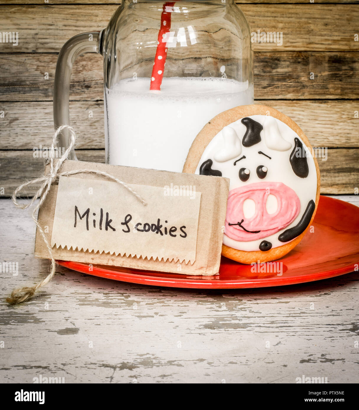 milk in a transparent jar with handle and baby biscuits as a cow on ...