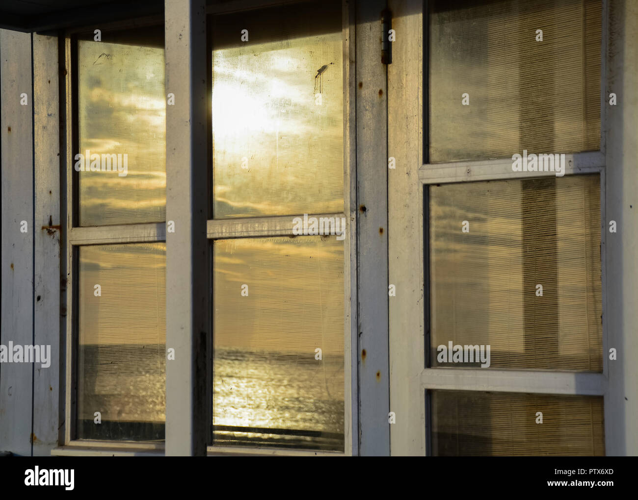 Sea reflected in beach hut windows Stock Photo - Alamy