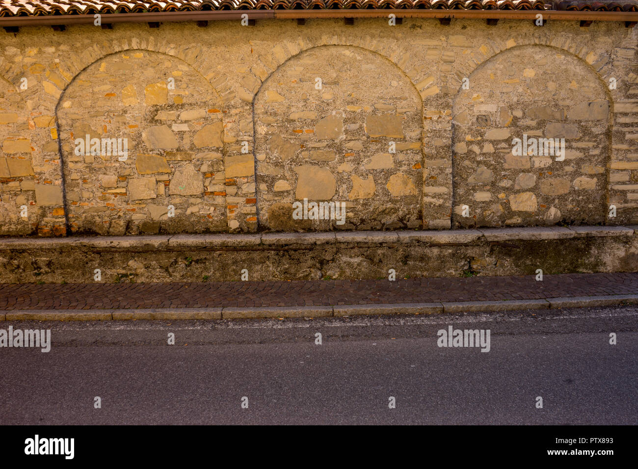 Italy, Menaggio, Lake Como, stone wall with arch Stock Photo - Alamy