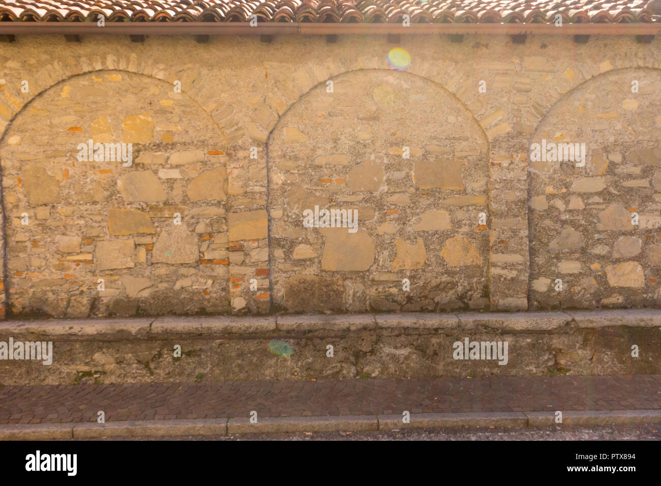 Italy, Menaggio, Lake Como, stone wall with arch Stock Photo - Alamy