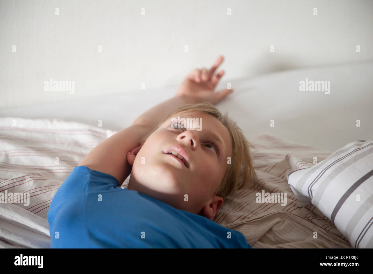 Boy laying awake in bed hi-res stock photography and images - Alamy