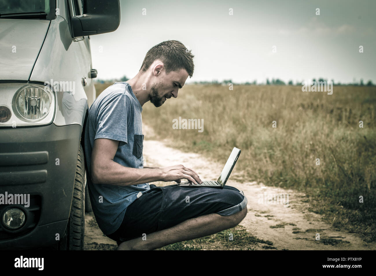 man running on the computer in nature near the car Stock Photo - Alamy