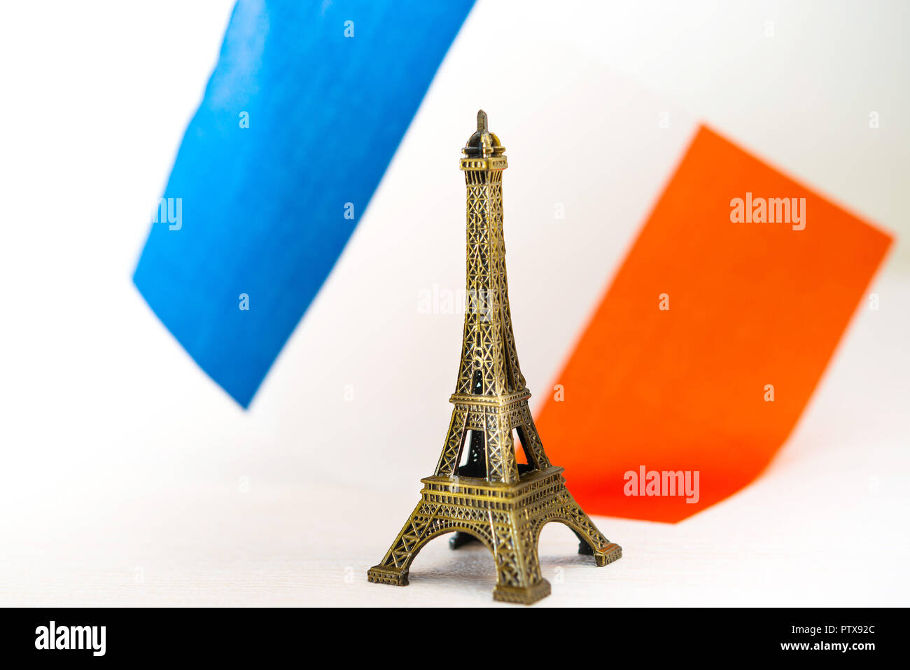 Metal Eiffel Tower and French flag on background Stock Photo - Alamy
