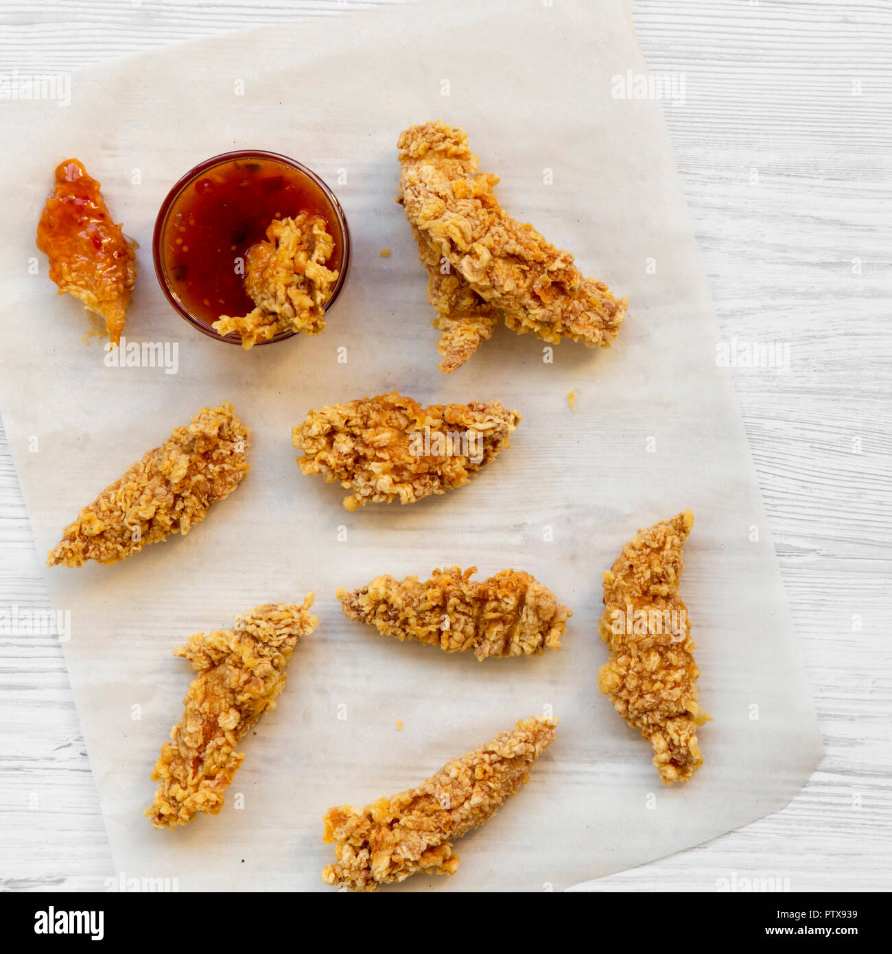 Fried chicken tenders with sauce on white wooden background, top view ...