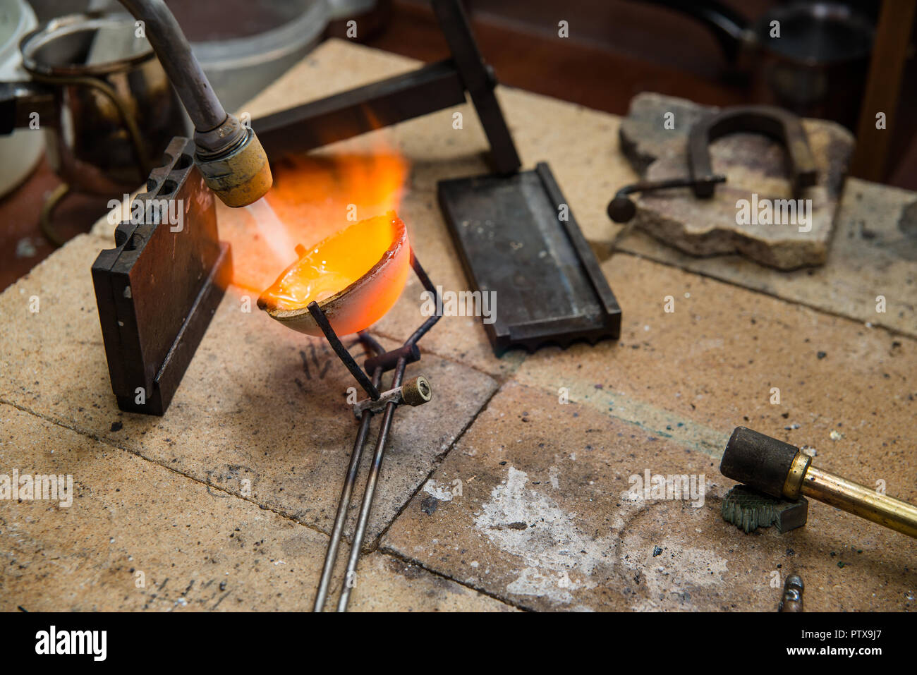 Jeweller melts gold gas burner Stock Photo - Alamy