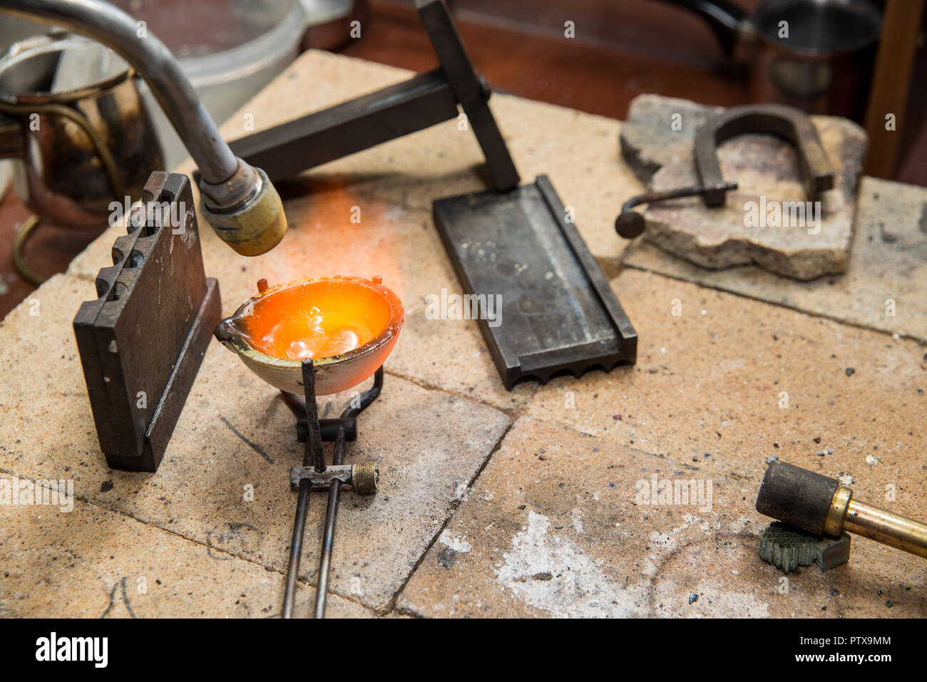 Jeweller melts gold gas burner Stock Photo - Alamy