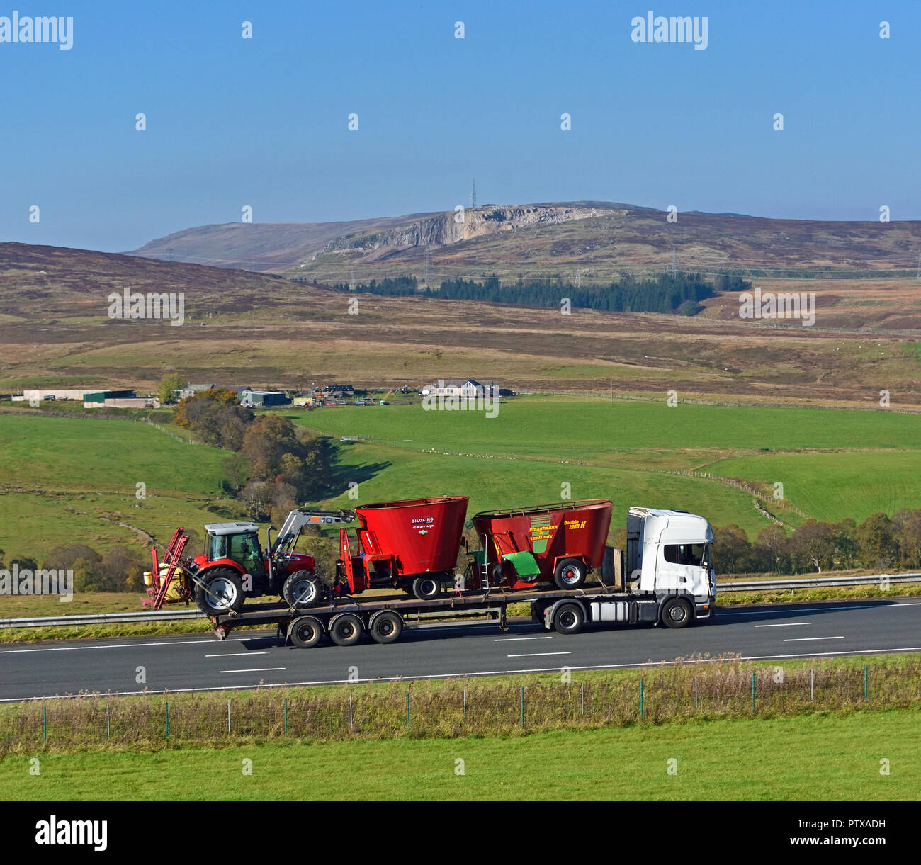 Low-loader HGV carrying farm equipment. M6 Northbound carriageway, Shap ...