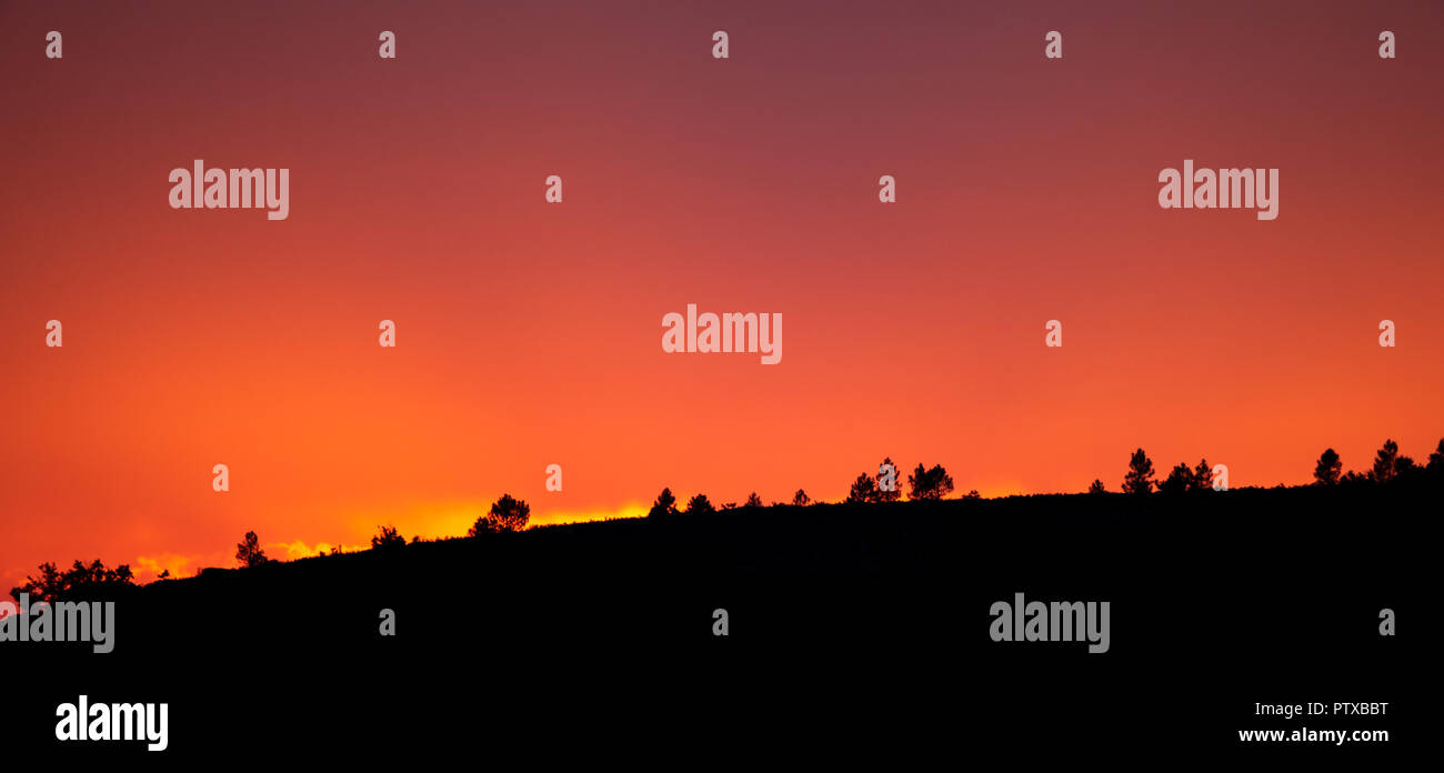 Sunset after the mountains high contrast profile Stock Photo - Alamy