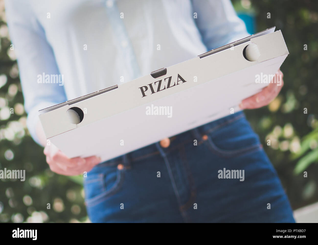 Pizza delivery woman holding pizza box Stock Photo - Alamy