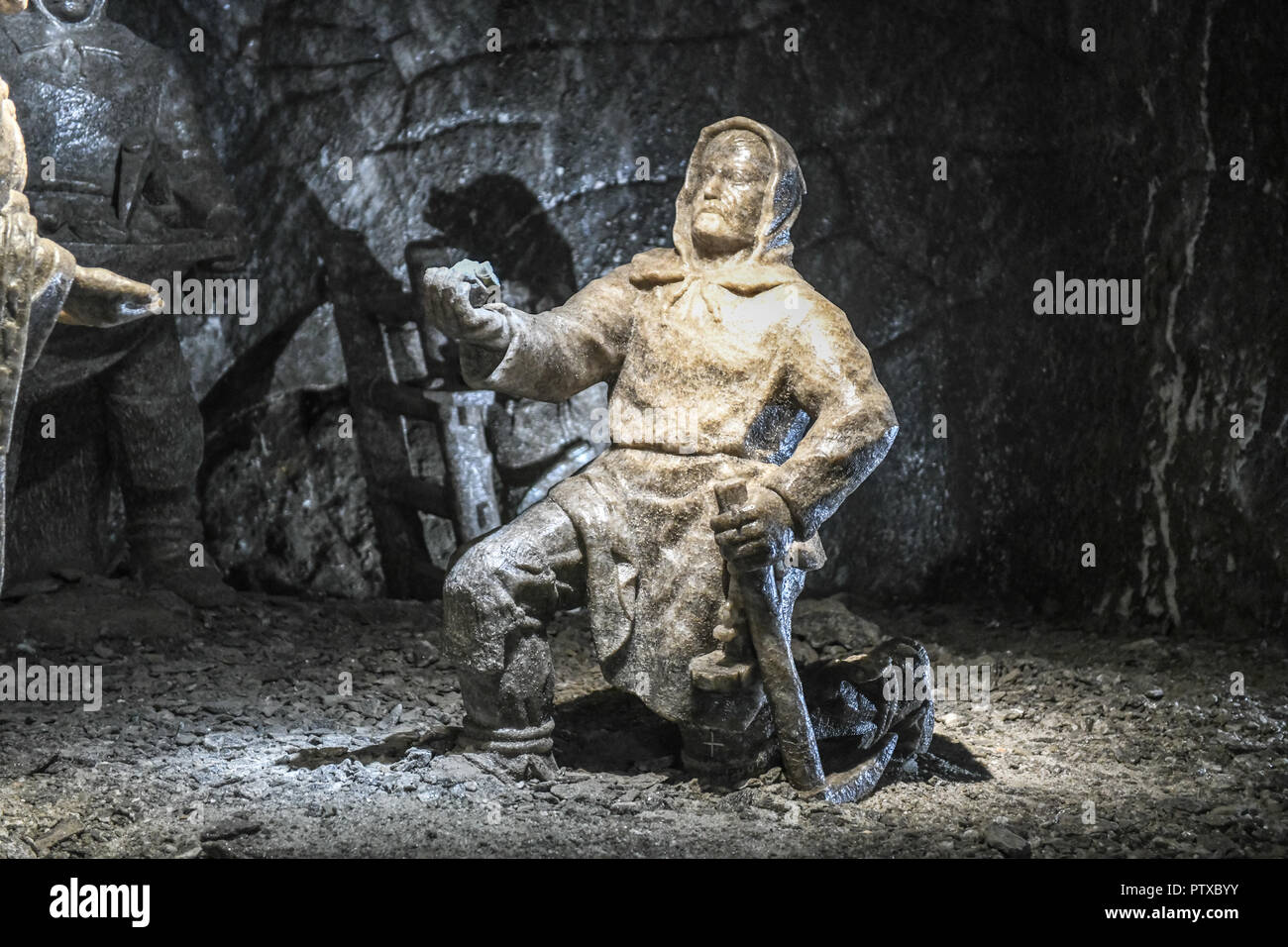 Statue of miner presenting the salt to queen in the Wieliczka Salt Mine ...