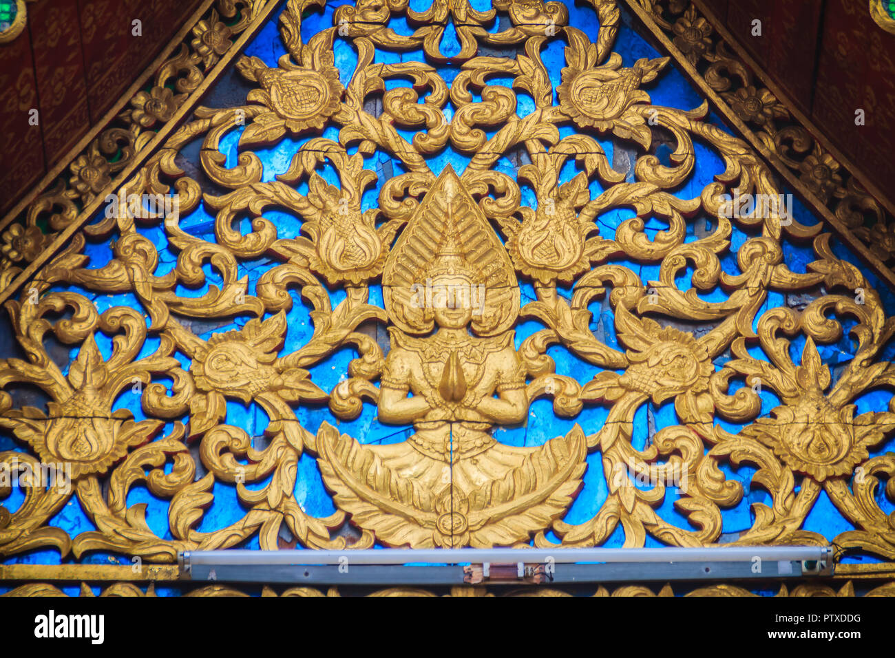 Beautiful golden gable chapel with engraved angel sculpture. An angel ...
