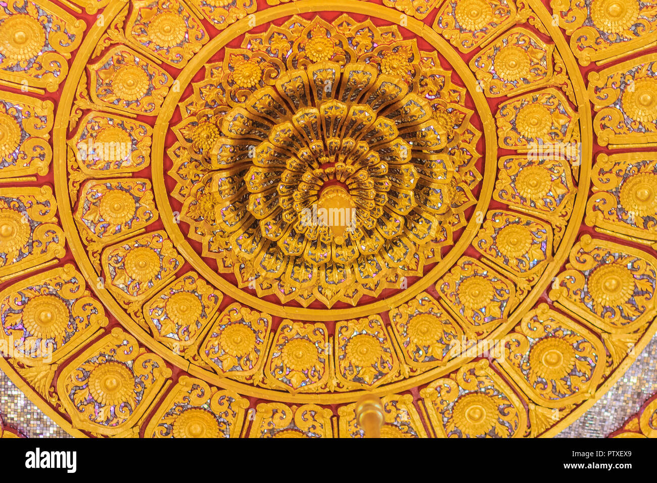 Beautiful golden decorated ceiling in lotus shape with lamp at the ...