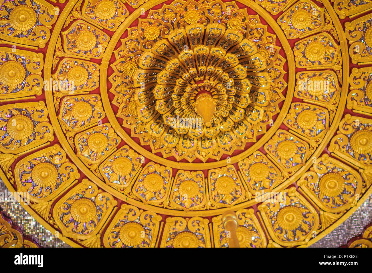 Beautiful golden decorated ceiling in lotus shape with lamp at the ...