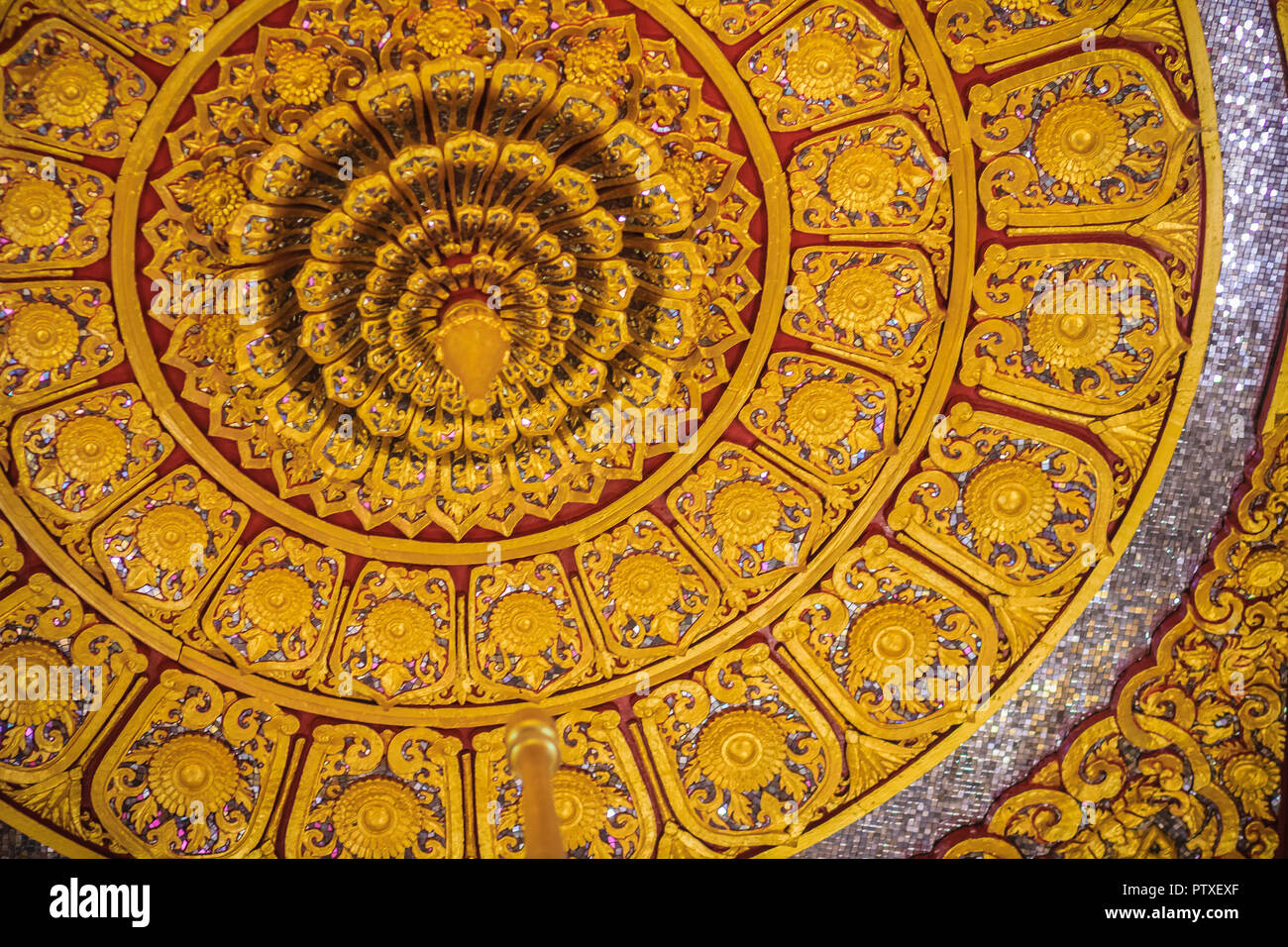 Beautiful golden decorated ceiling in lotus shape with lamp at the ...