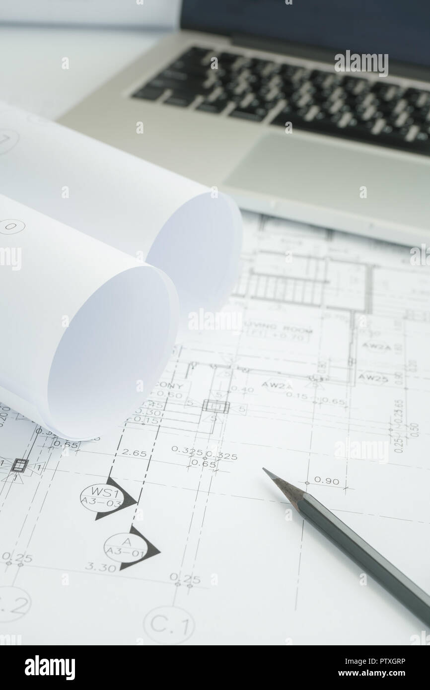 black pencil and computer laptop on architectural drawing paper for ...