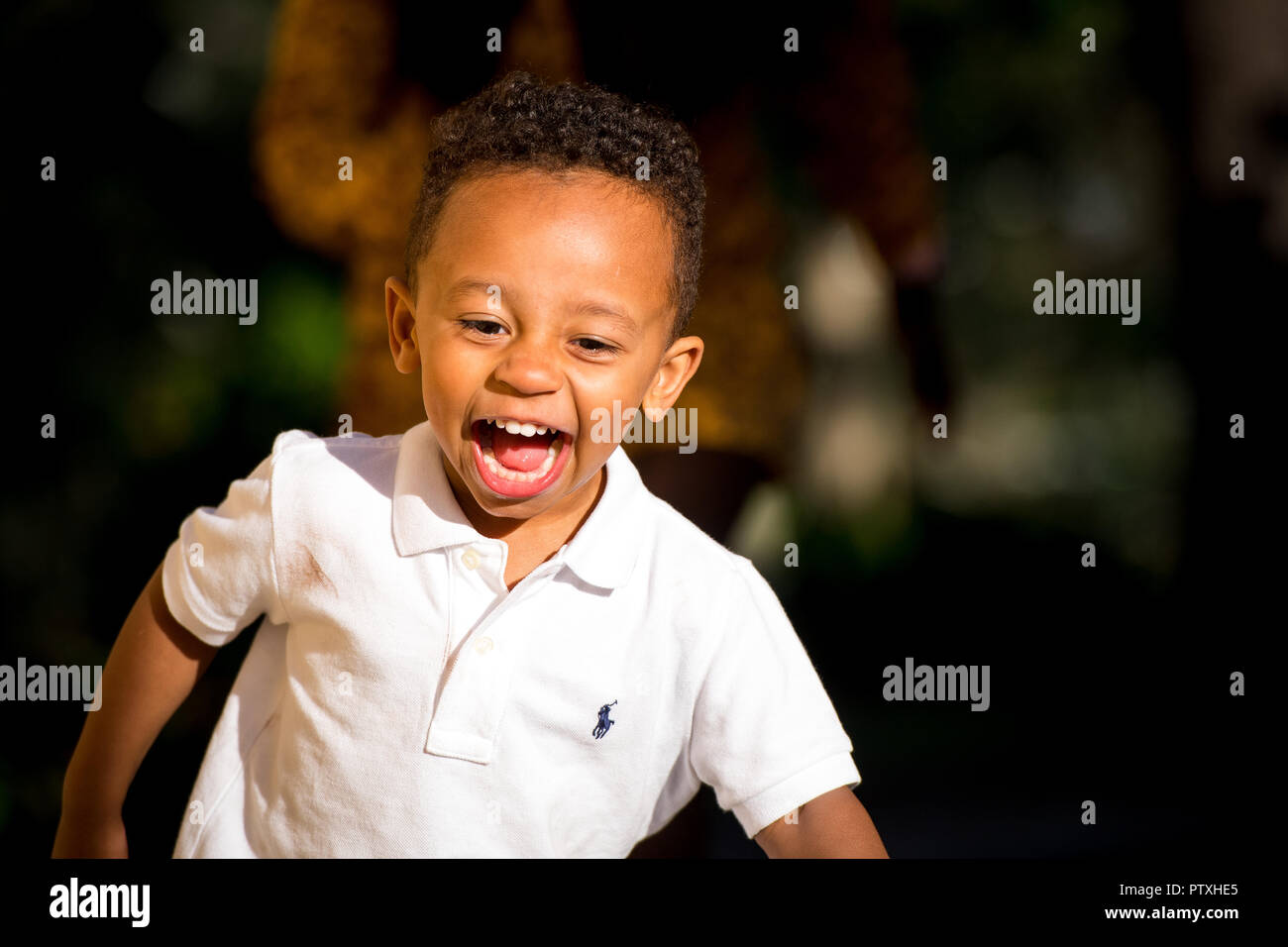 Young cute boy running and laughing Stock Photo - Alamy