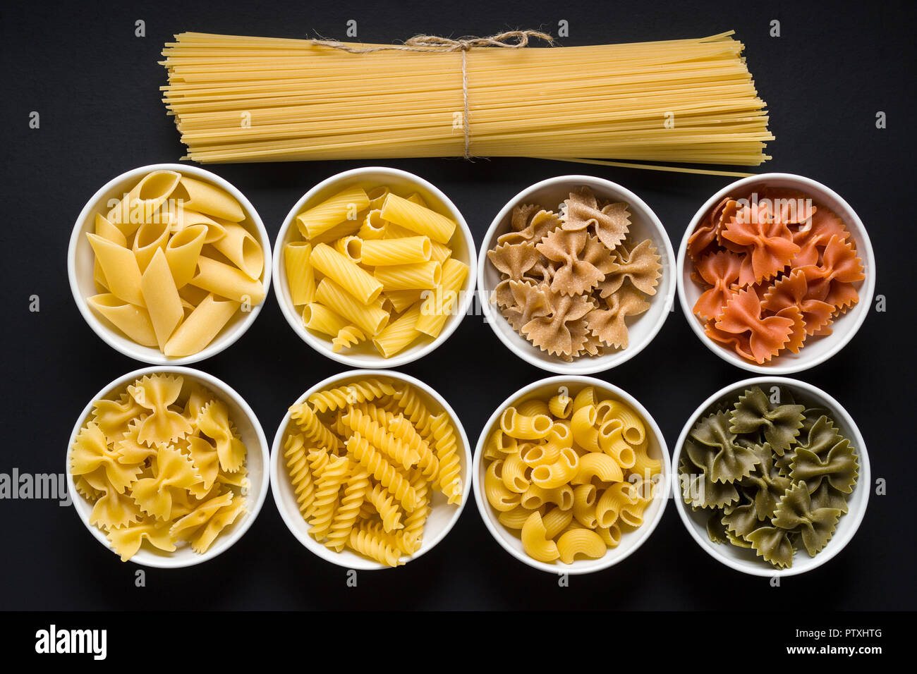 Various types of italian pasta in bowl on black background Stock Photo ...