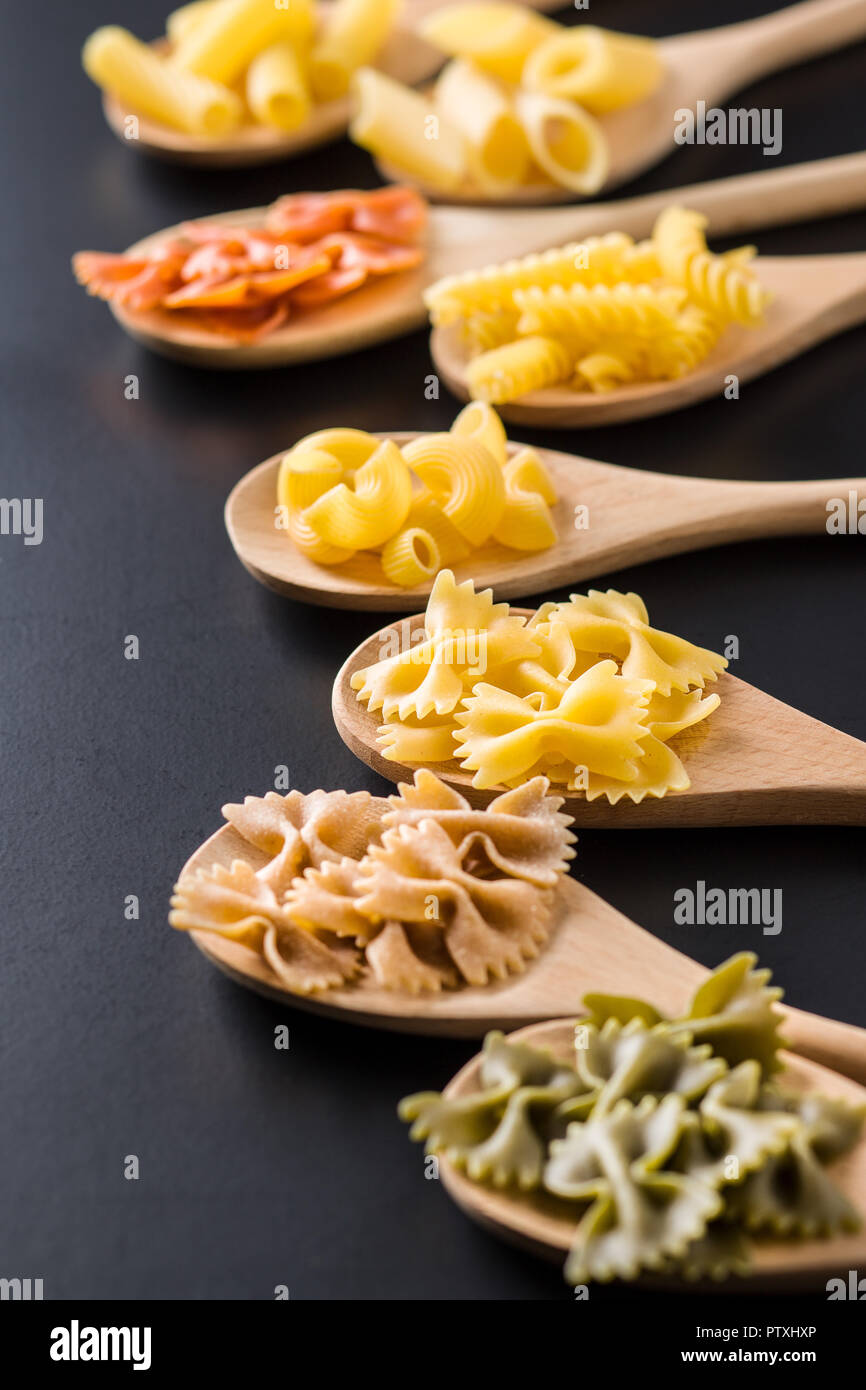 Various types of italian pasta in wooden spoon Stock Photo - Alamy