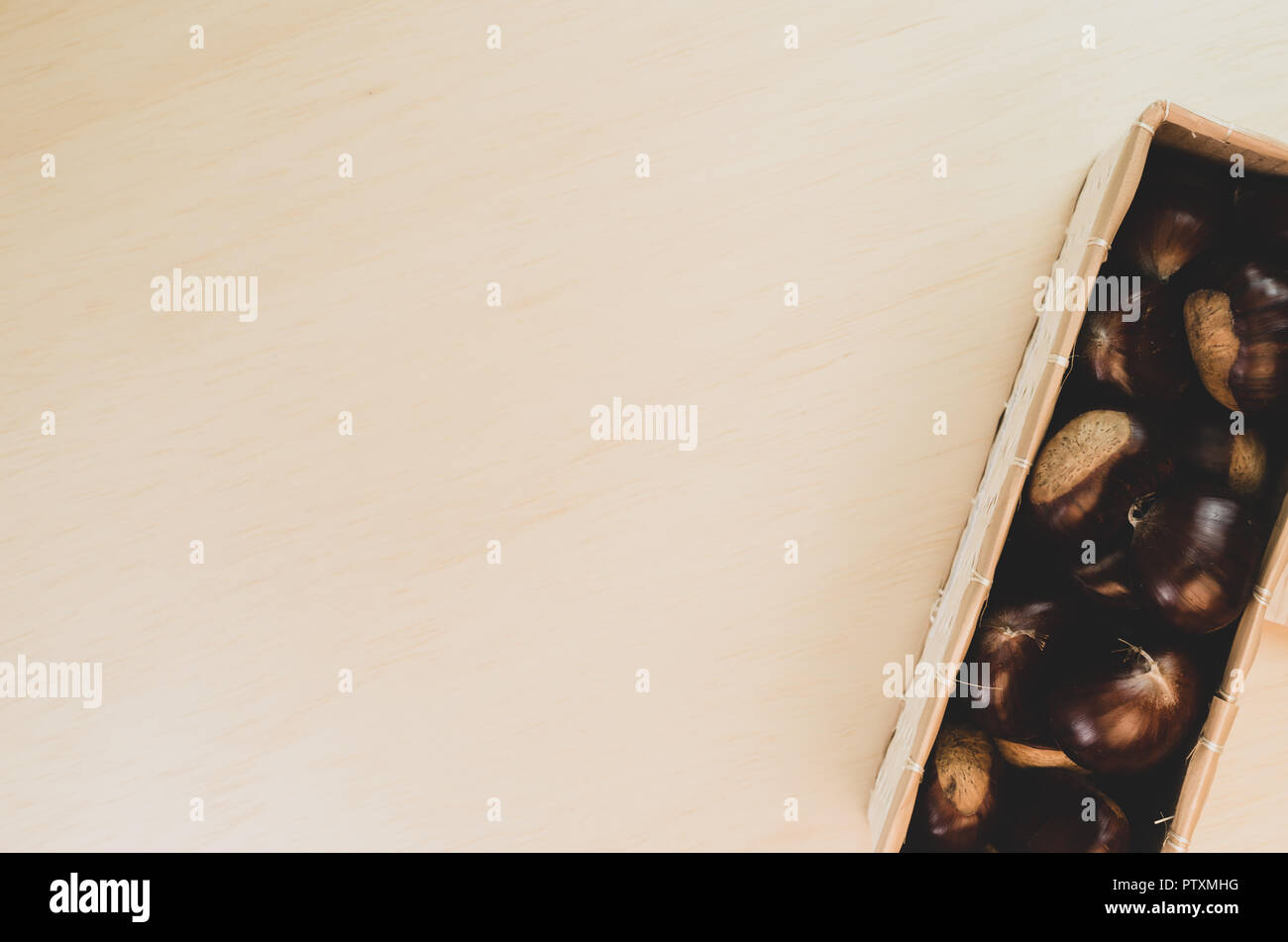 chestnuts on a light wooden surface - organic fruits concepts Stock ...