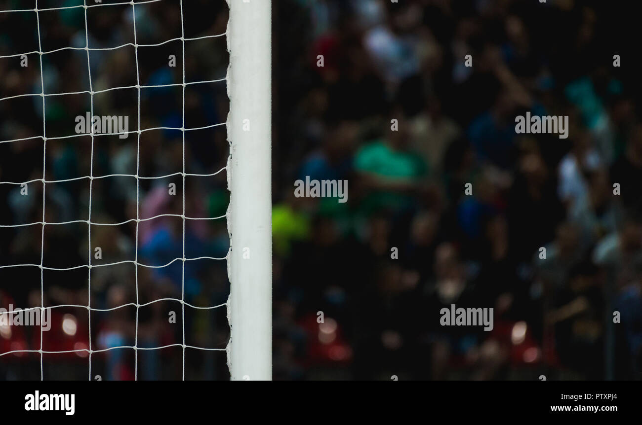 Soccer football net background over green grass and blurry stadium ...
