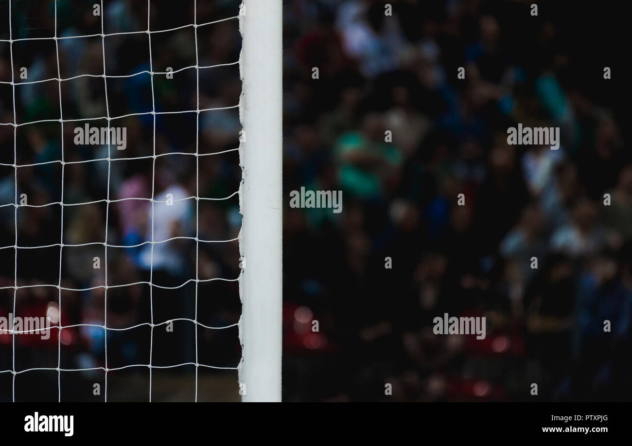 Soccer football net background over green grass and blurry stadium ...
