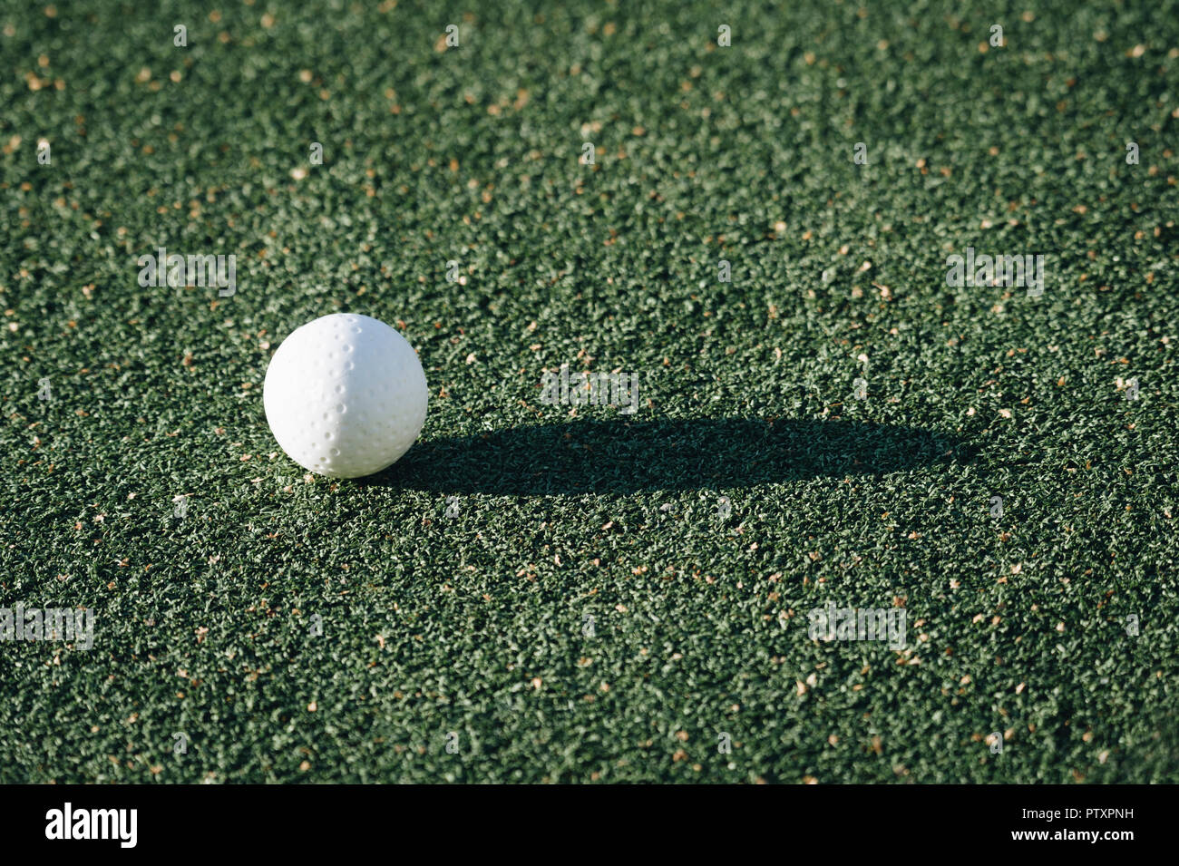 White dimple hockey ball on astro turf Stock Photo - Alamy