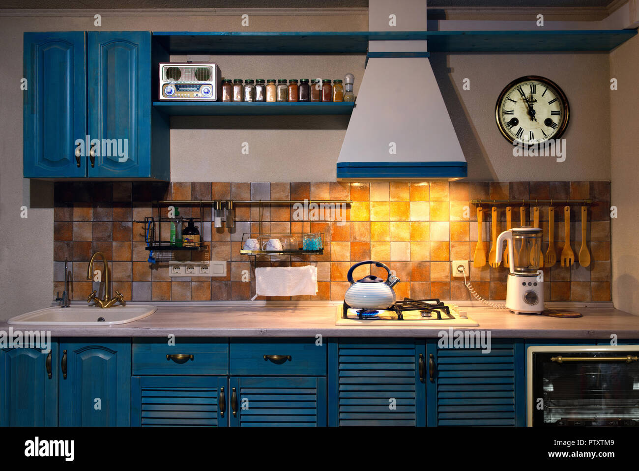 Kitchen with blue boiling kettle in the interior Stock Photo - Alamy