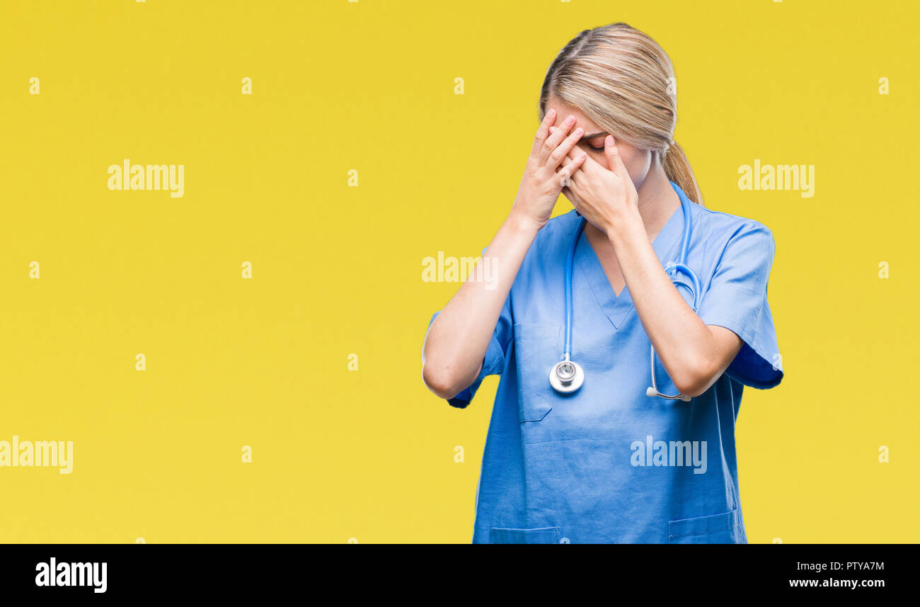 Young beautiful blonde doctor surgeon nurse woman over isolated ...