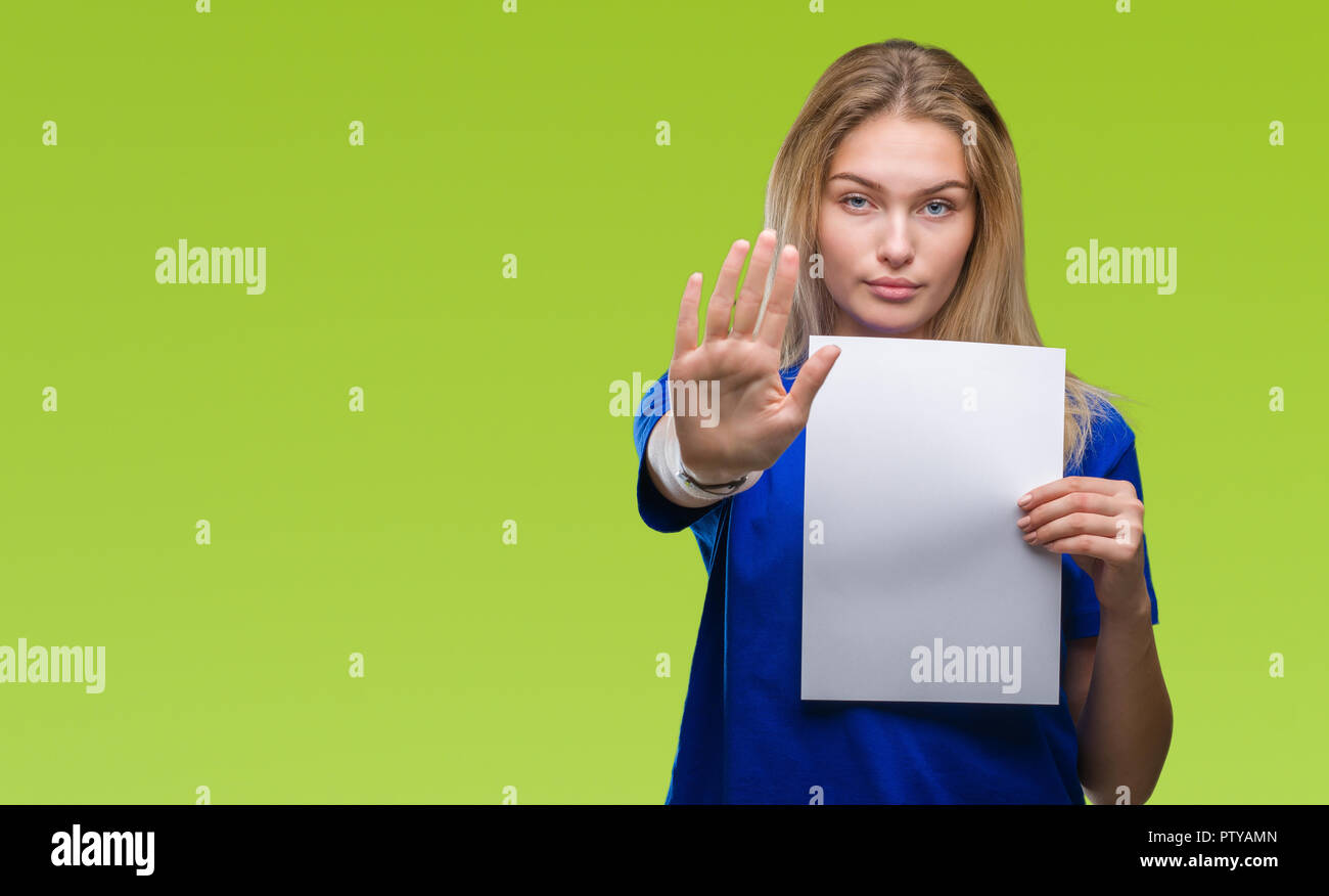 Young caucasian woman holding blank paper sheet over isolated ...