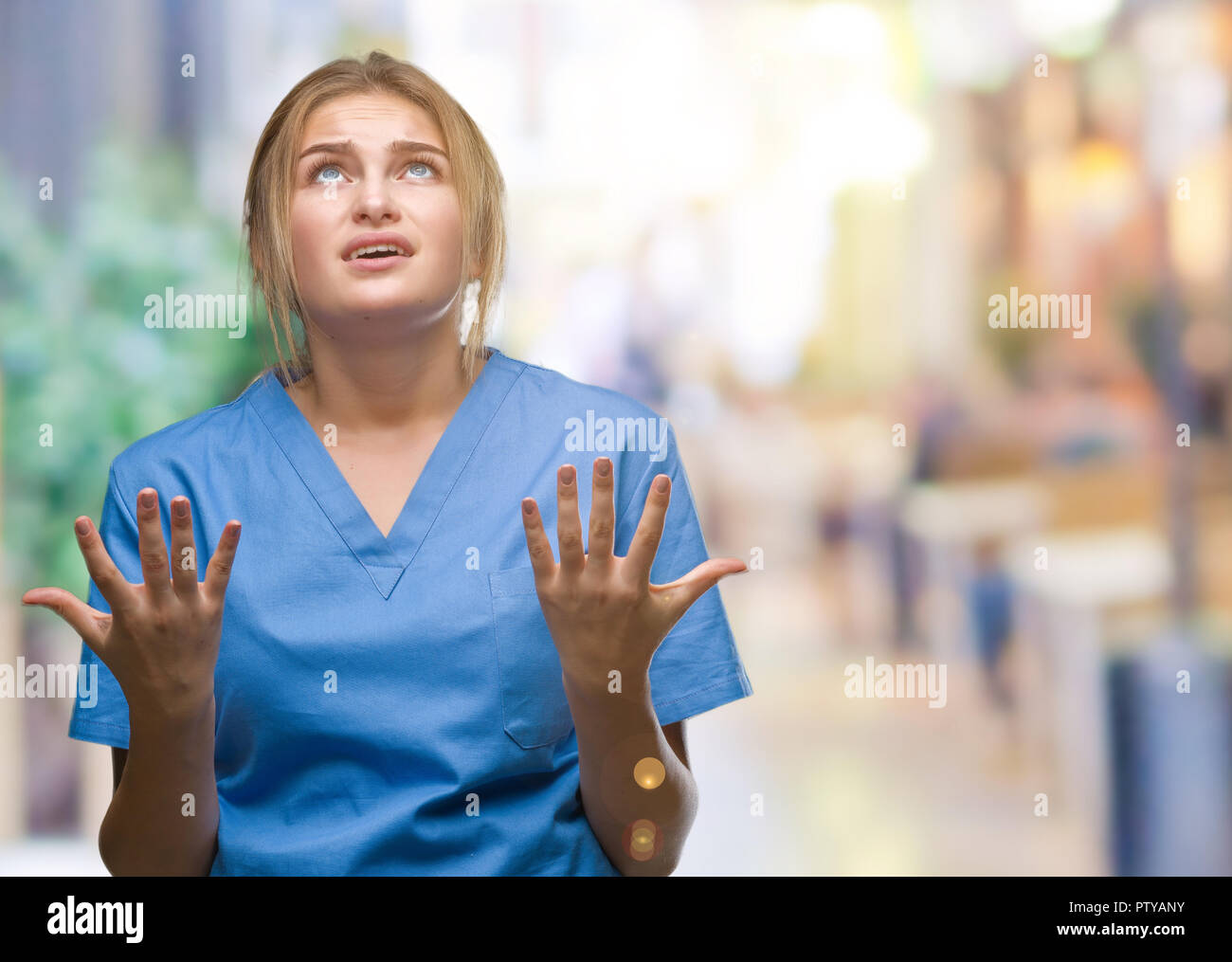 Young caucasian nurse woman wearing surgeon uniform over isolated ...